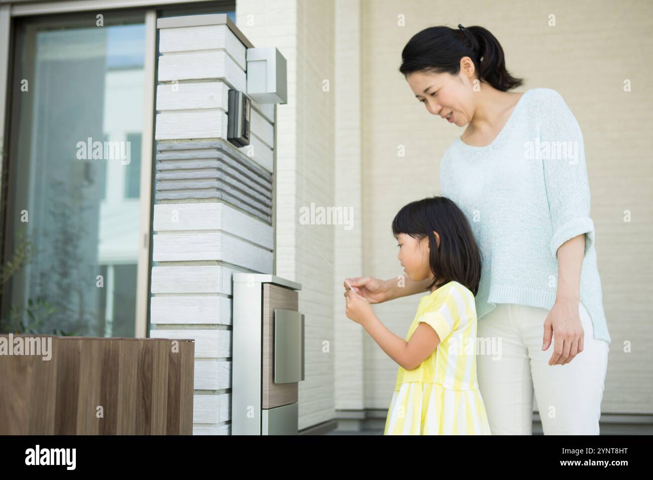 Parents and children checking mail Stock Photo - Alamy