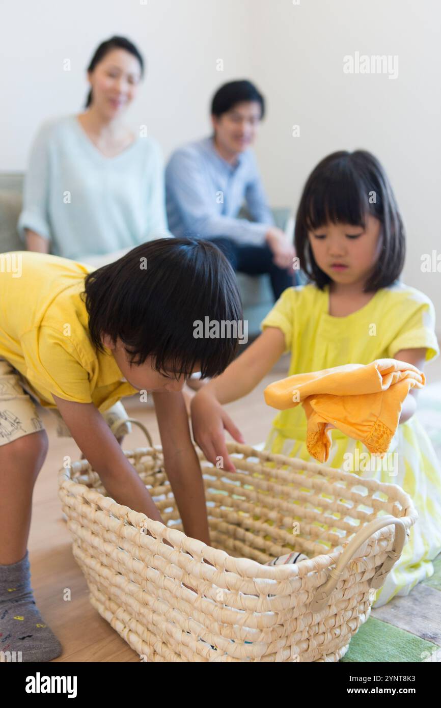 Laundry woman folding clothes home hi-res stock photography and images - Alamy