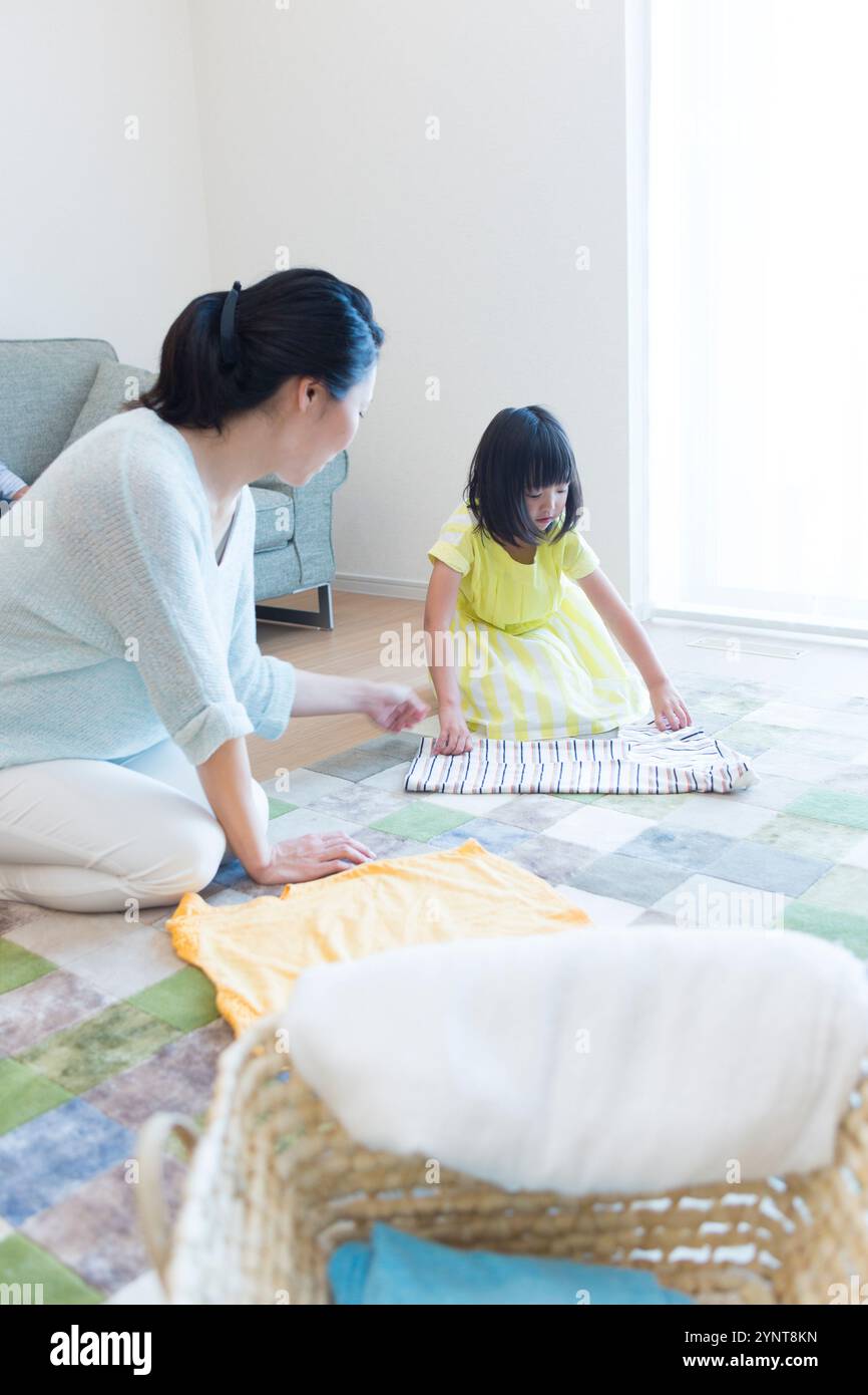 Family folding clothes hi-res stock photography and images - Alamy