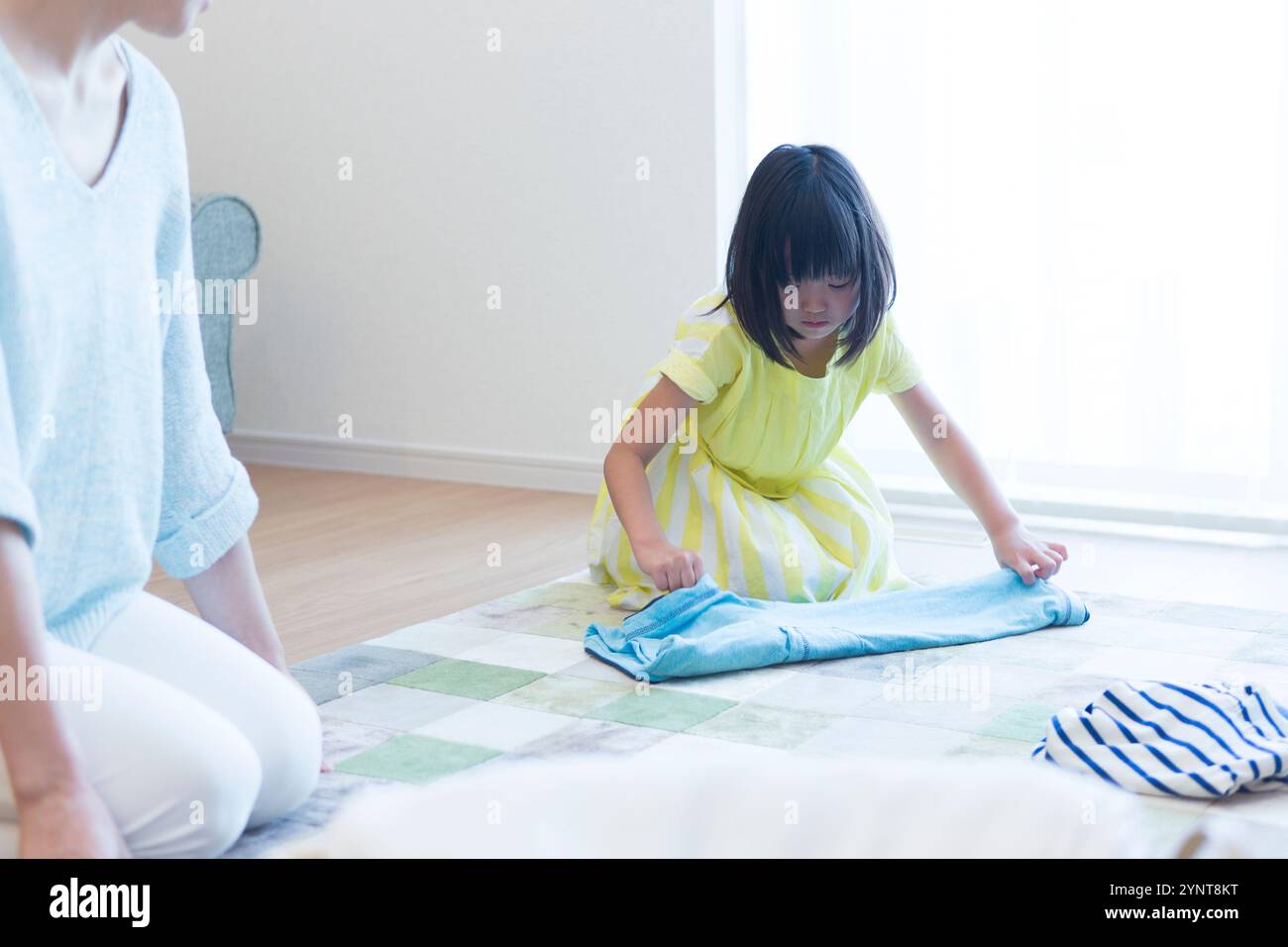 Laundry woman folding clothes hi-res stock photography and images - Alamy
