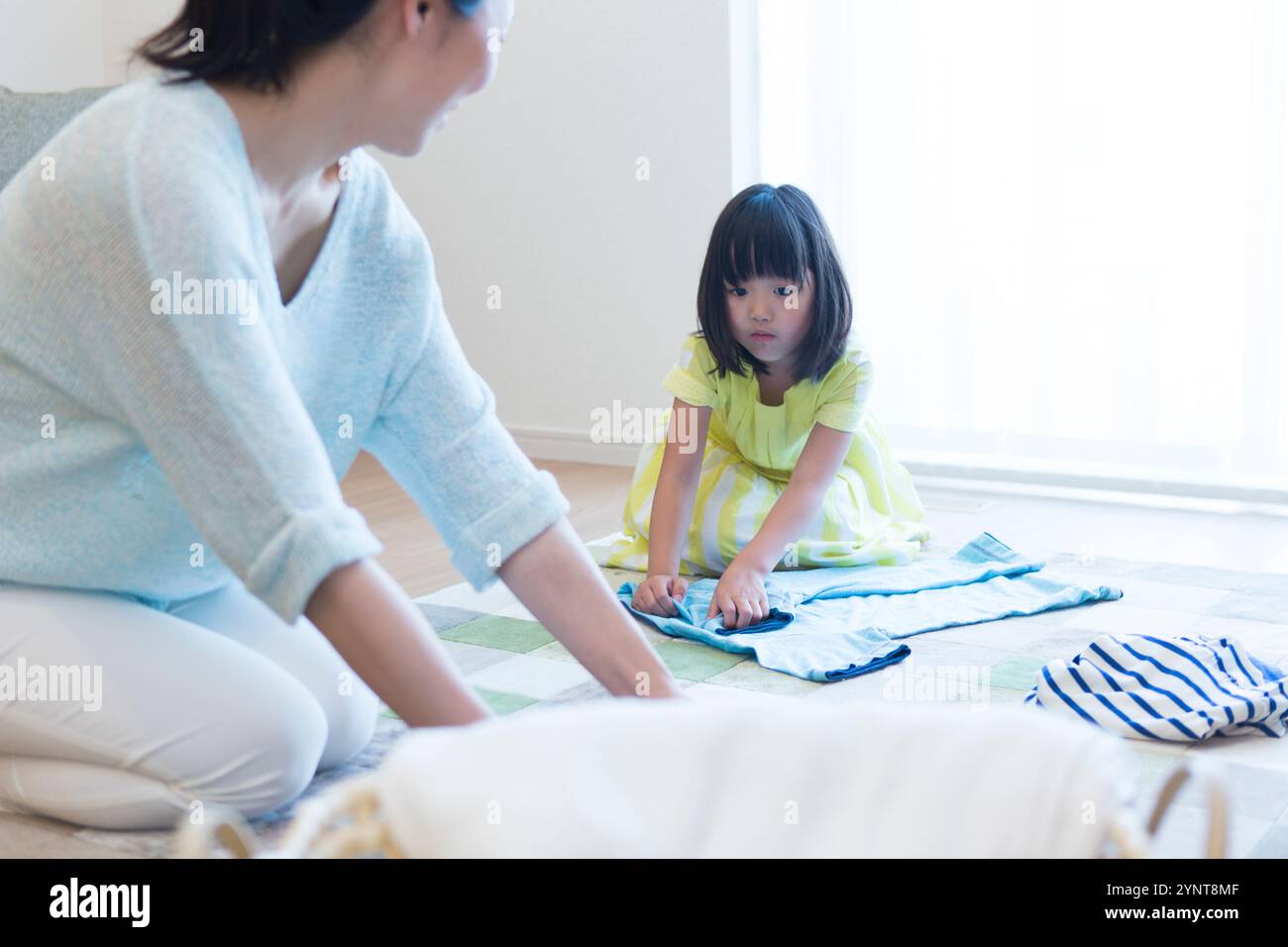 Laundry woman folding clothes hi-res stock photography and images - Alamy