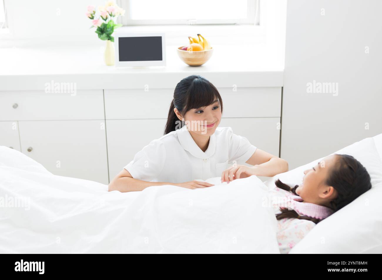 Girl and nurse sleeping in bed Stock Photo - Alamy