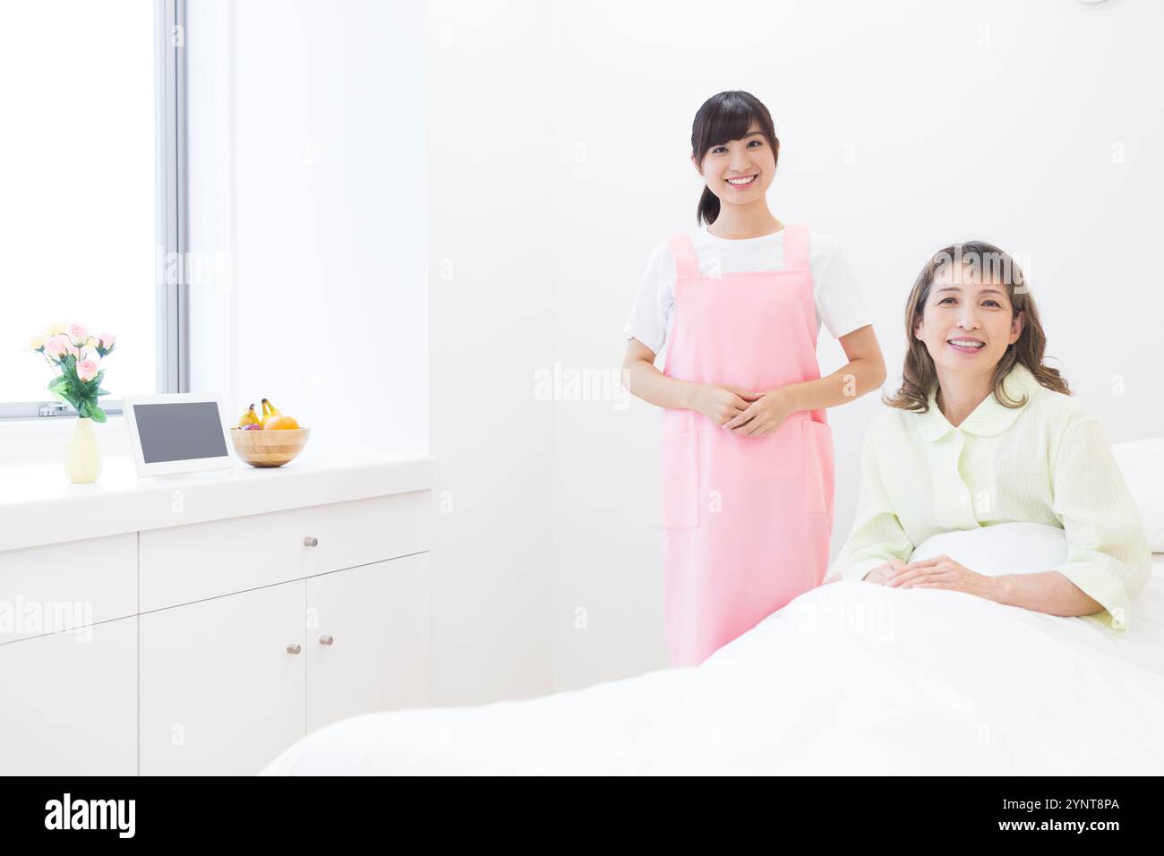 Woman and senior woman providing care Stock Photo - Alamy