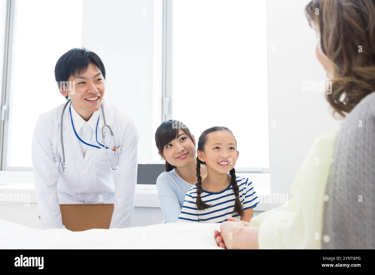 Senior woman with family members who came to visit her Stock Photo - Alamy