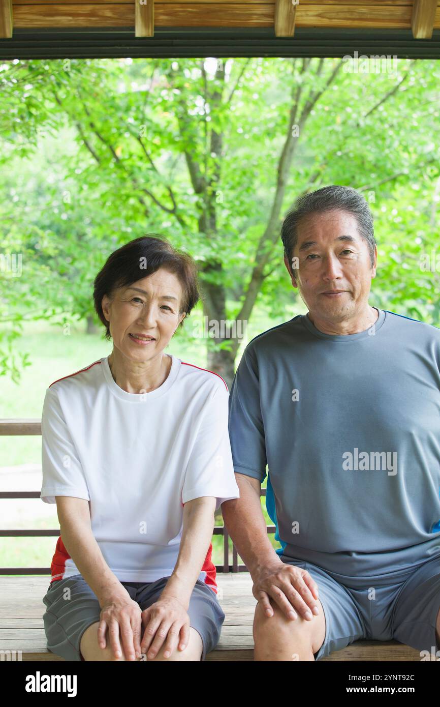 Senior citizen sitting on bench Stock Photo - Alamy
