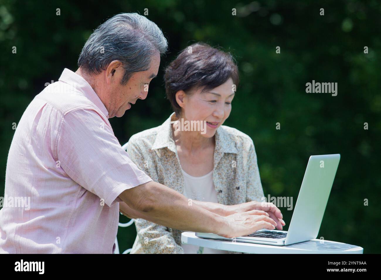 Senior citizen playing computer Stock Photo - Alamy