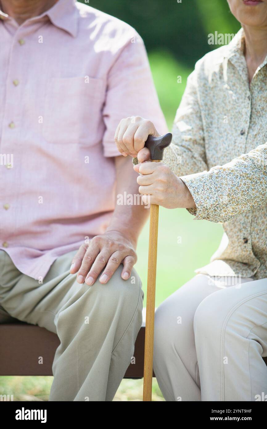 Senior citizen holding a cane Stock Photo - Alamy