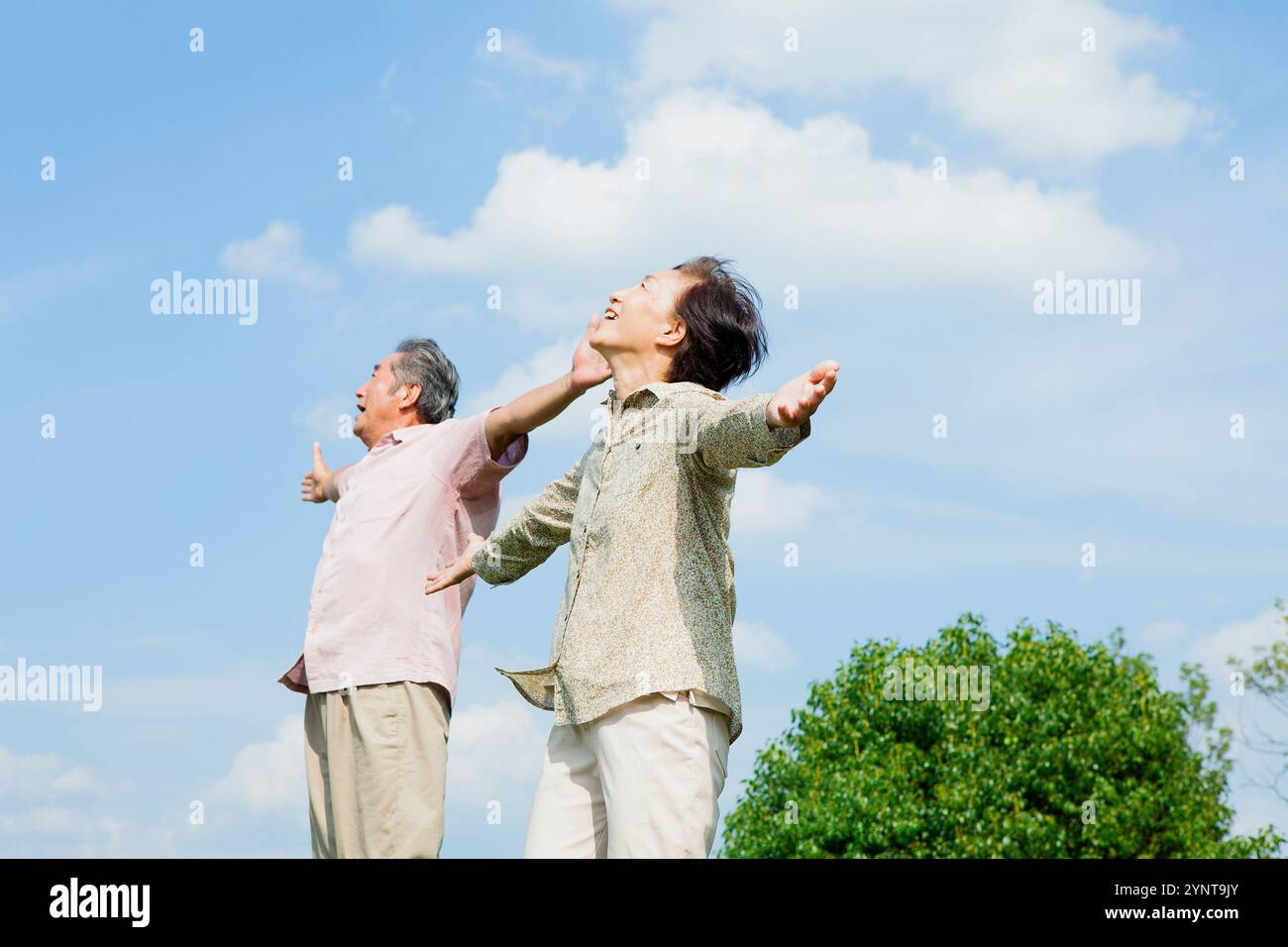 Couple spreading hands Stock Photo - Alamy