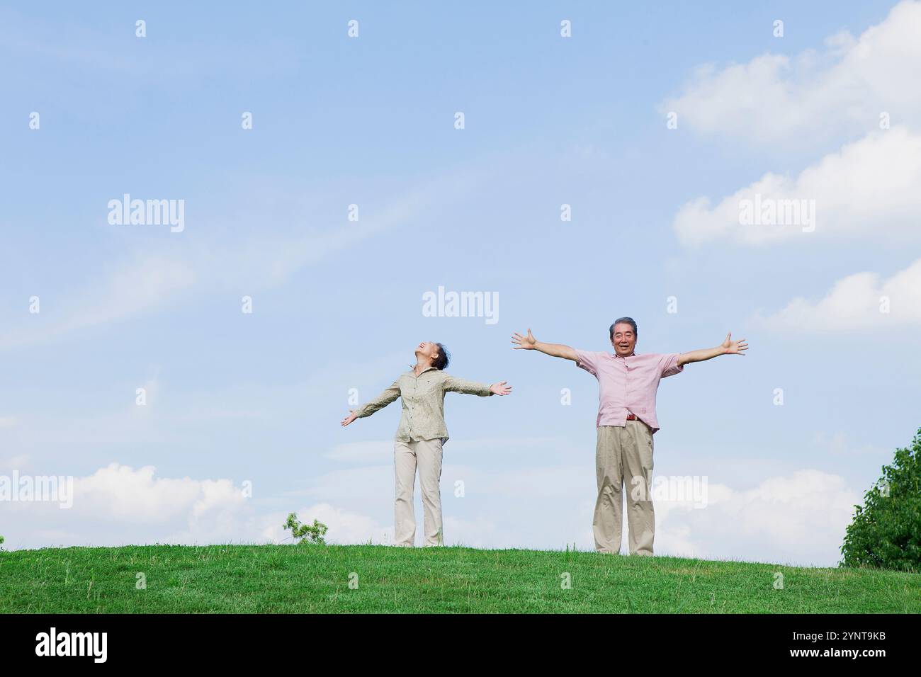 Couple spreading hands Stock Photo - Alamy