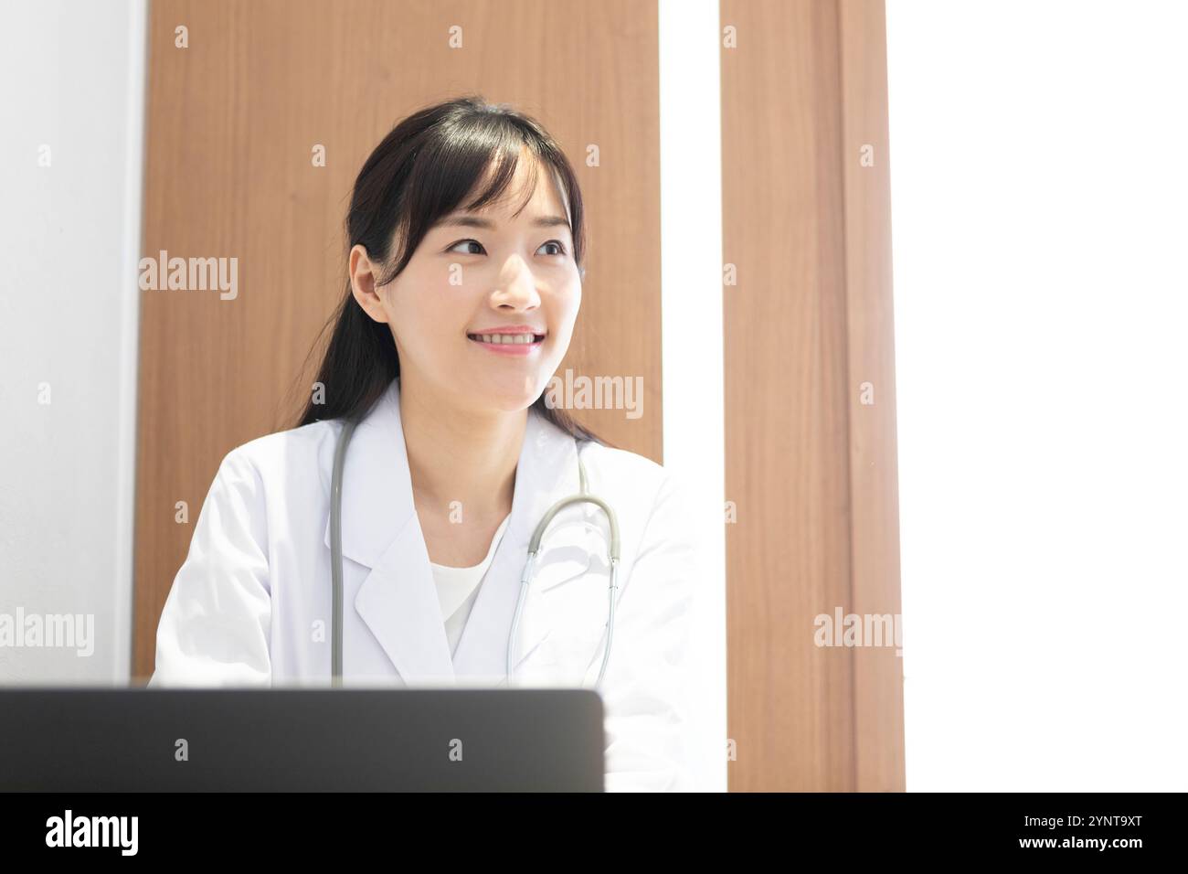 Female doctor typing on a computer Stock Photo - Alamy