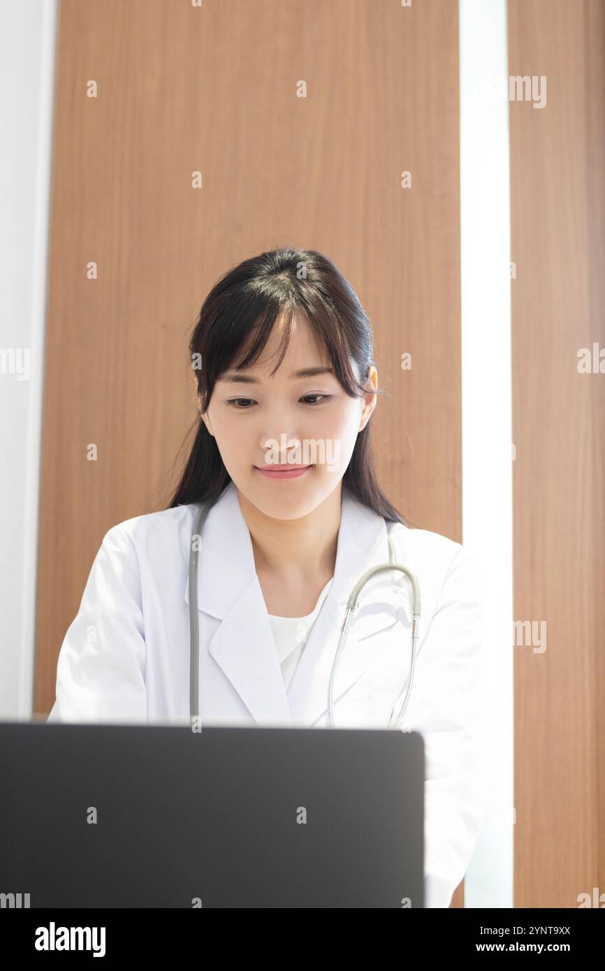 Female doctor typing on computer hi-res stock photography and images ...