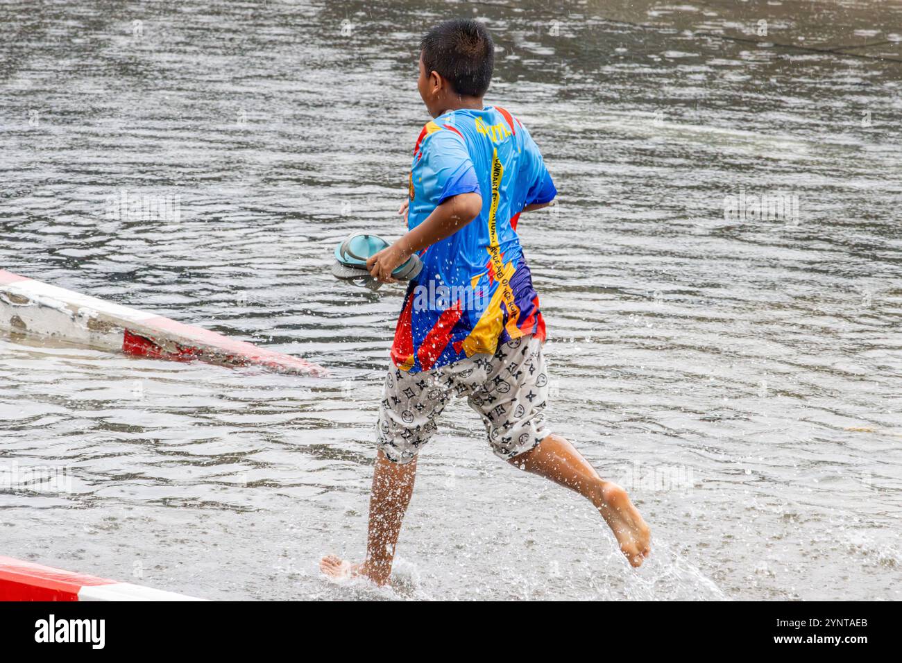 Child run through rain puddle hi-res stock photography and images - Alamy