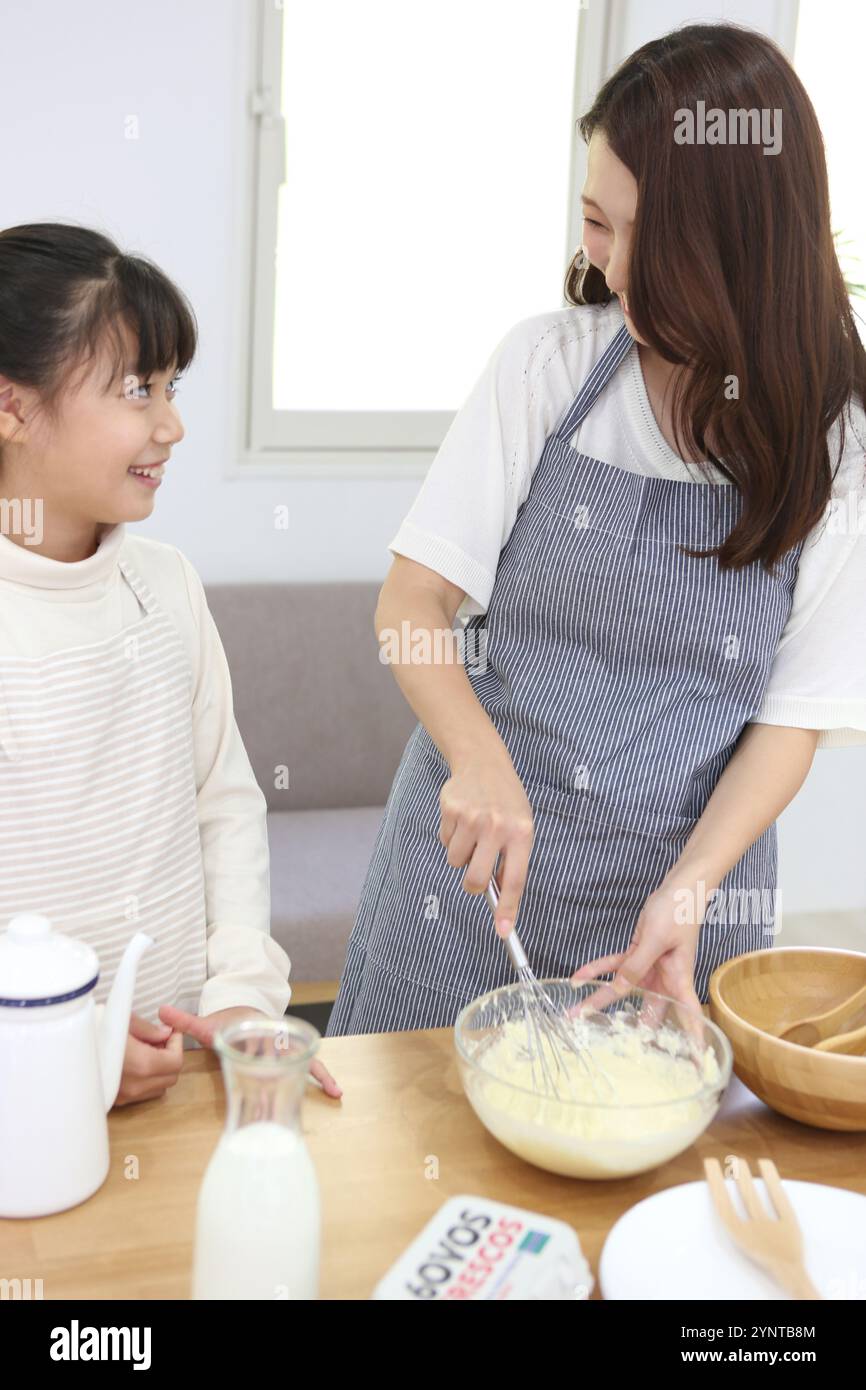 Parent and child cooking Stock Photo - Alamy