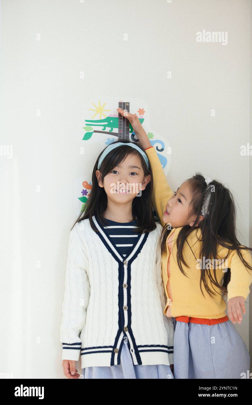 Children in back-to-back comparison Stock Photo - Alamy