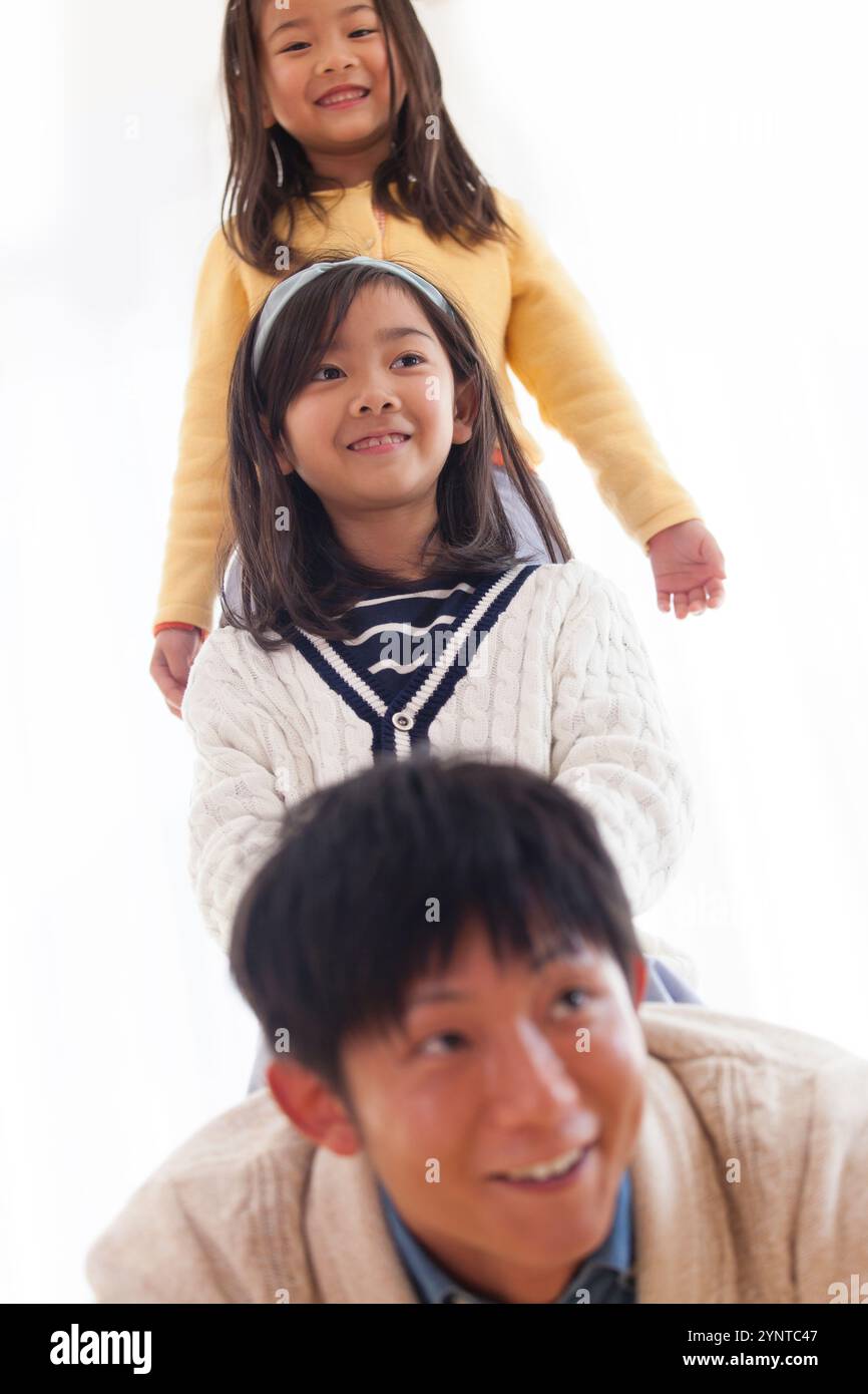 Father putting his child on his back Stock Photo - Alamy
