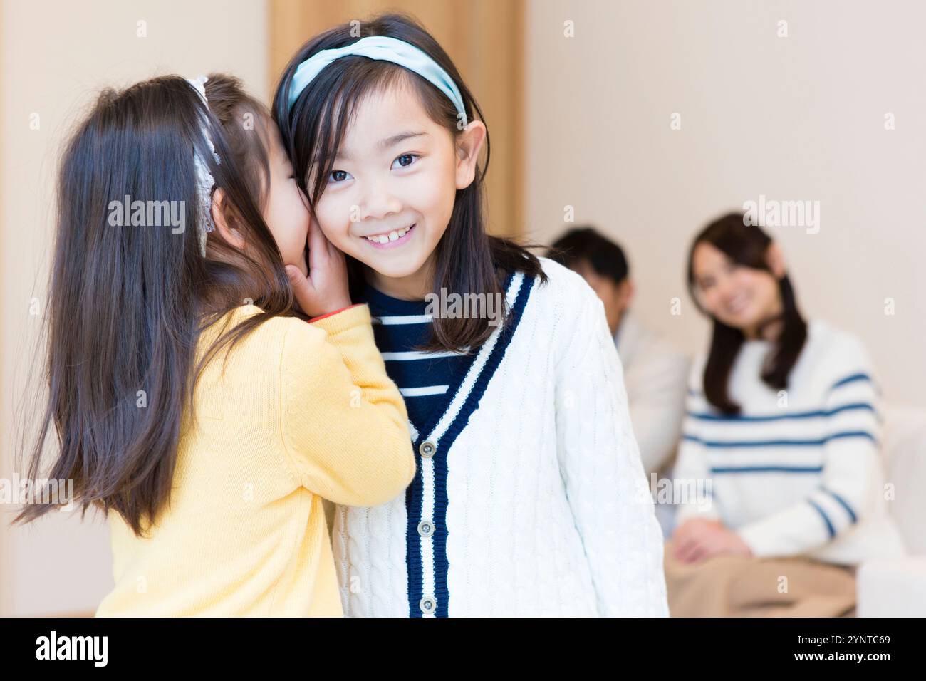 Sisters whispering in secret Stock Photo - Alamy