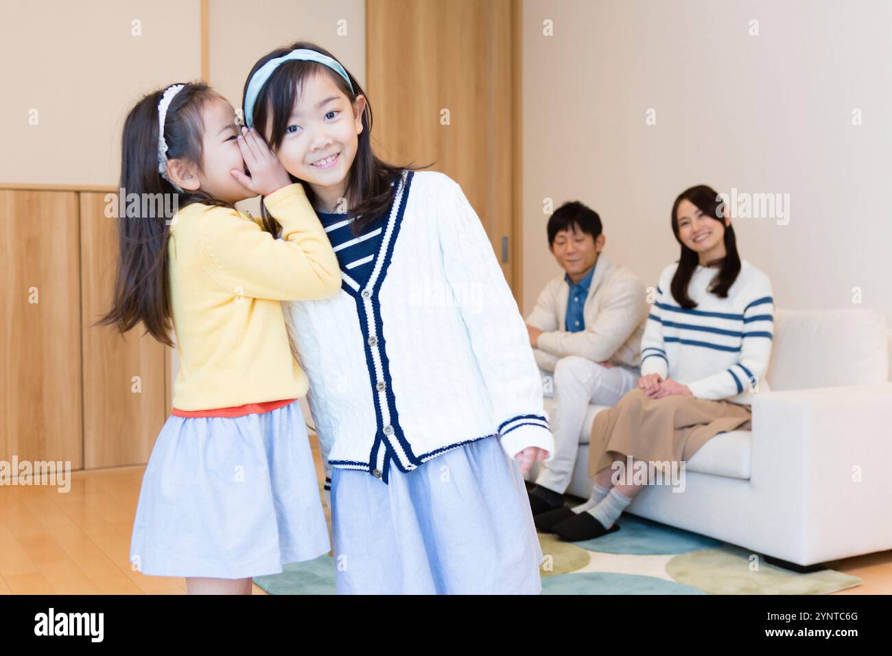 Sisters whispering in secret Stock Photo - Alamy