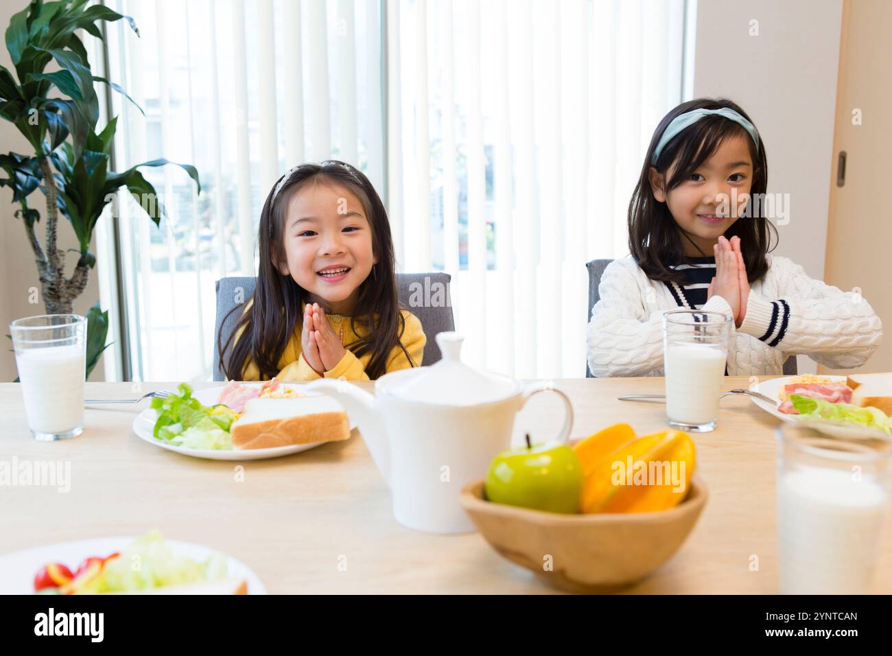Breakfast scene with sisters Stock Photo - Alamy
