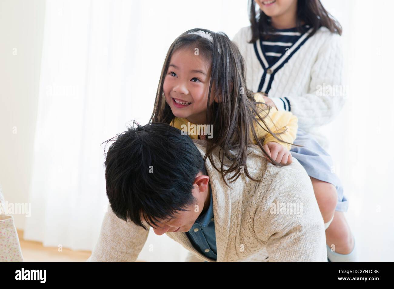 Father putting his child on his back Stock Photo - Alamy