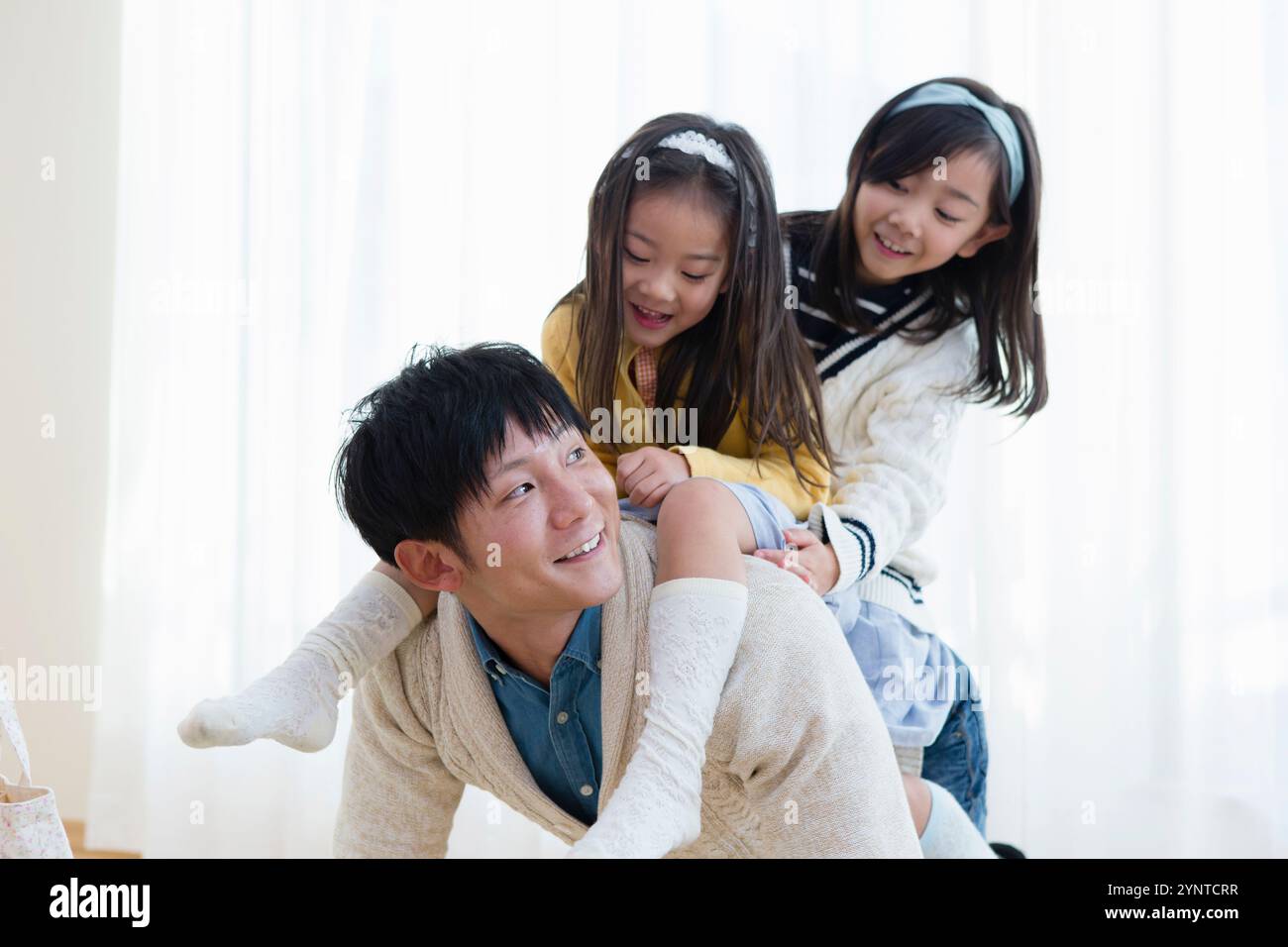 Father putting his child on his back Stock Photo - Alamy