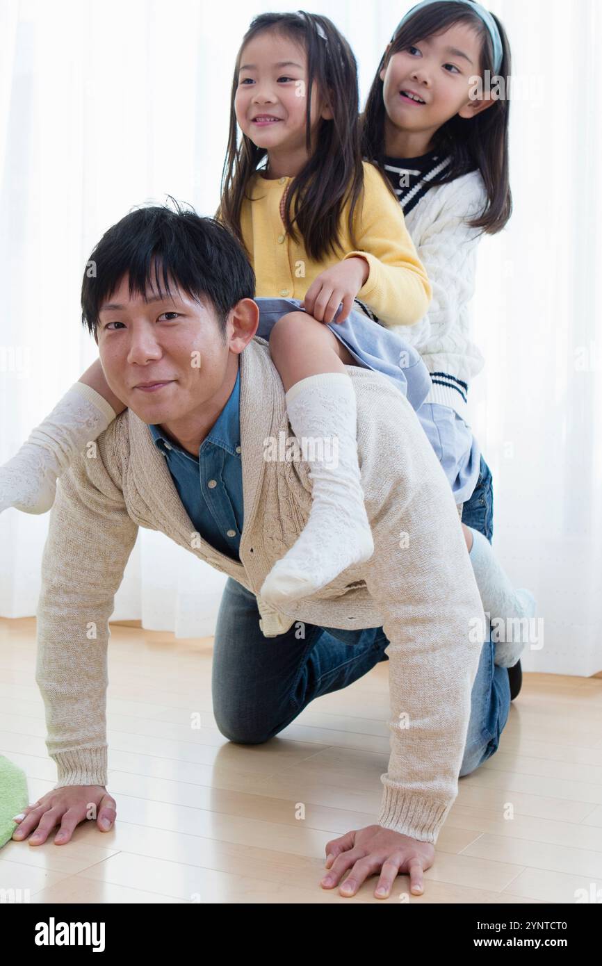 Father putting his child on his back Stock Photo - Alamy