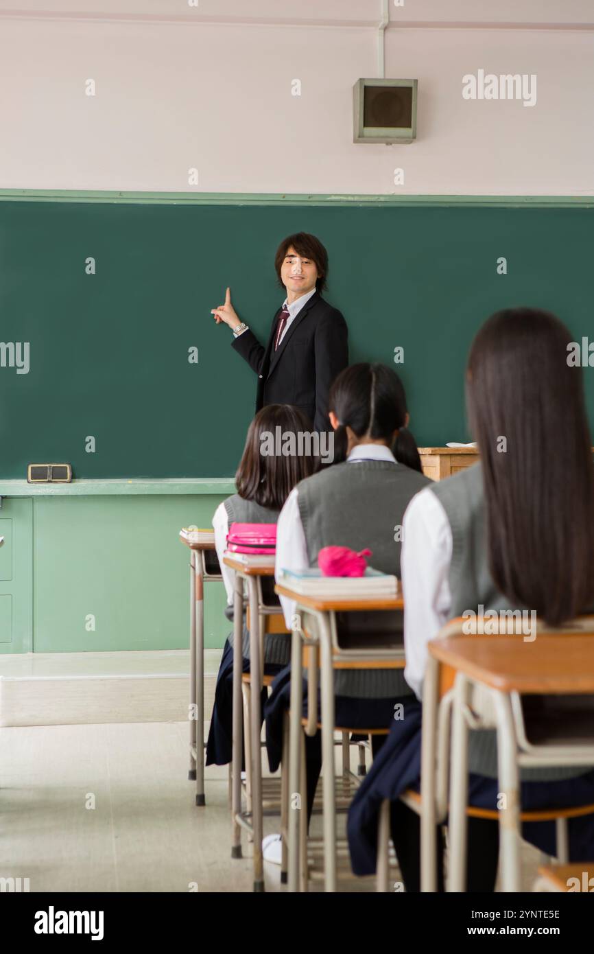 Teacher and female student in class Stock Photo - Alamy
