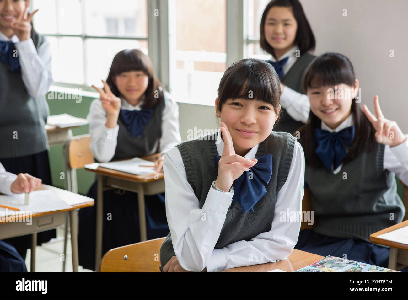 Schoolgirl making peace sign Stock Photo - Alamy
