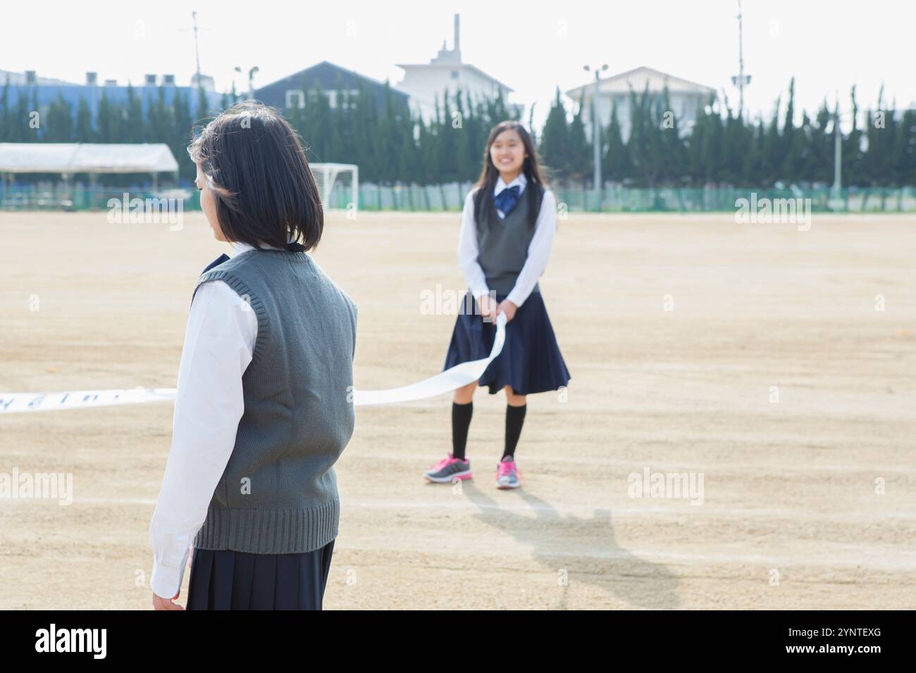 Female student standing on the ground Stock Photo - Alamy