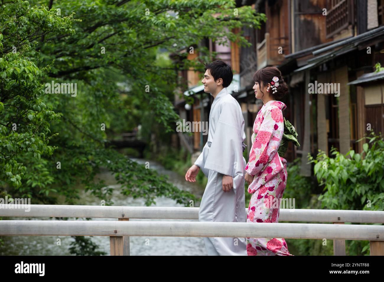 Couple crossing the bridge Stock Photo - Alamy