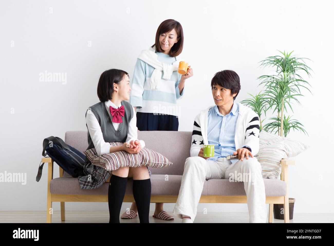 Family grouping together in a room Stock Photo - Alamy