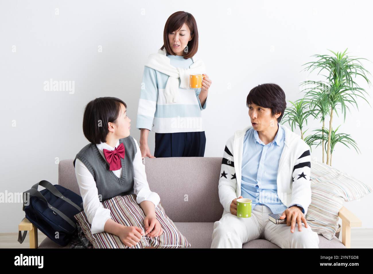 Family grouping together in a room Stock Photo - Alamy