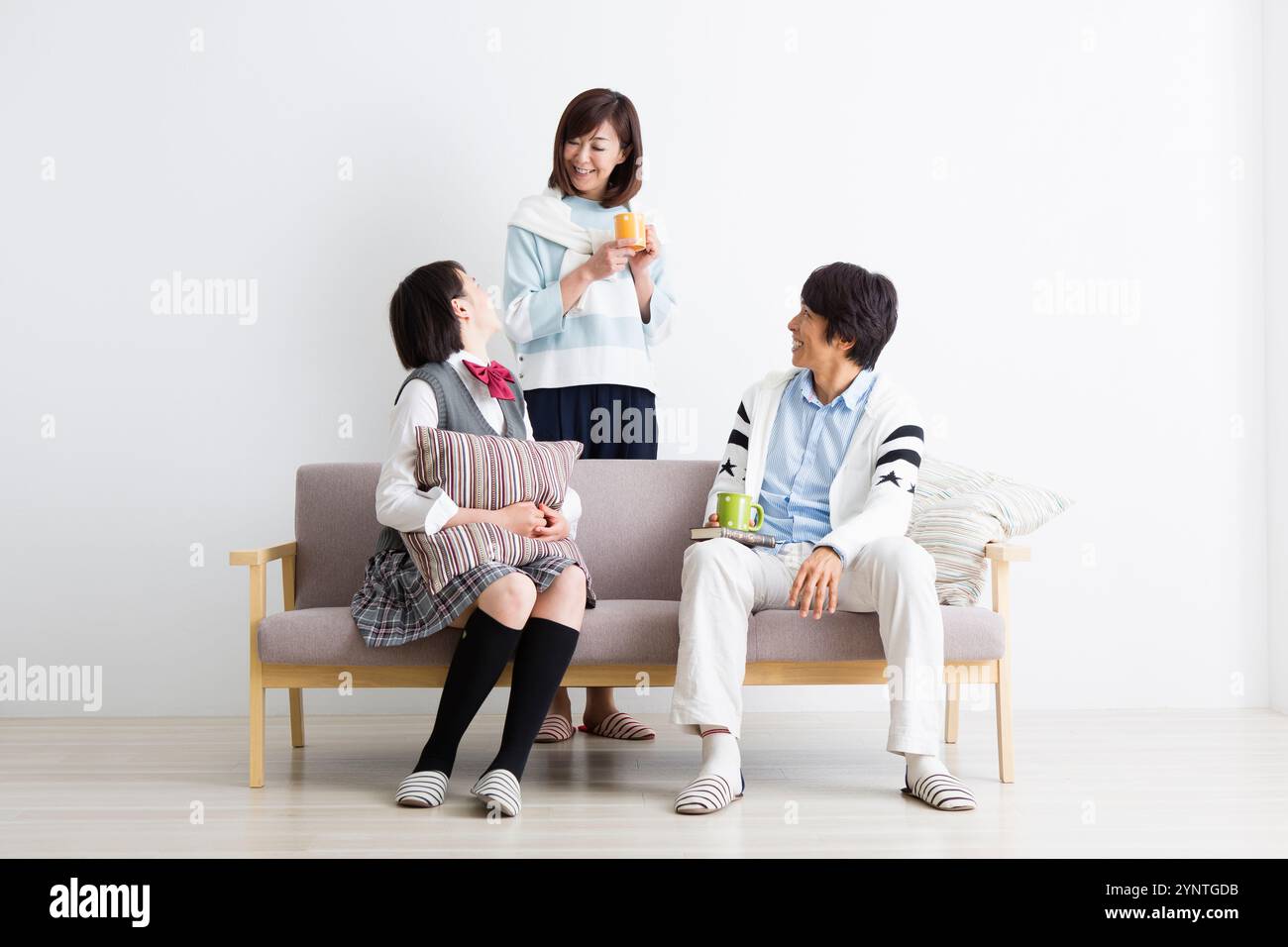 Family grouping together in a room Stock Photo - Alamy