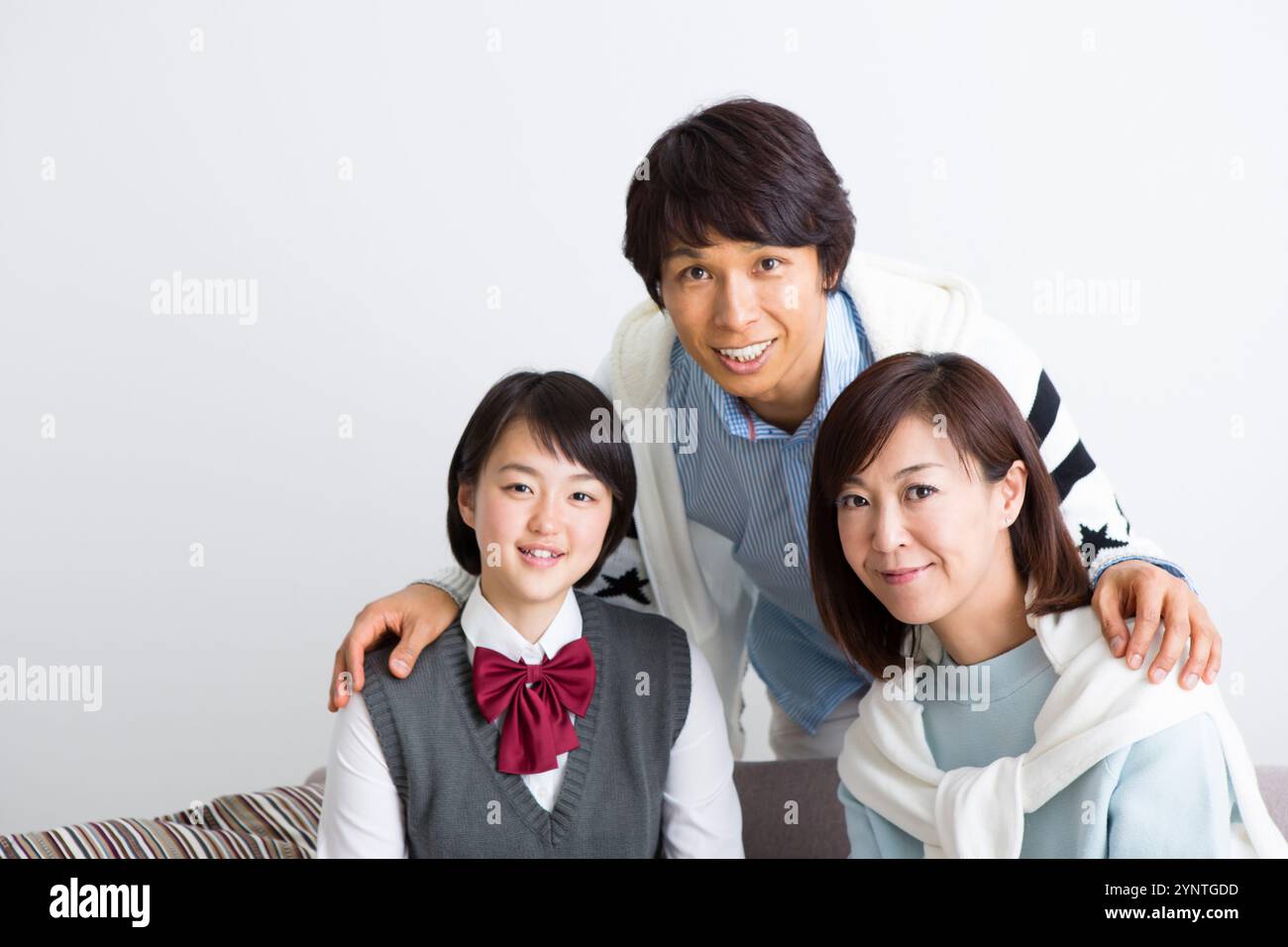 Family grouping together in a room Stock Photo - Alamy