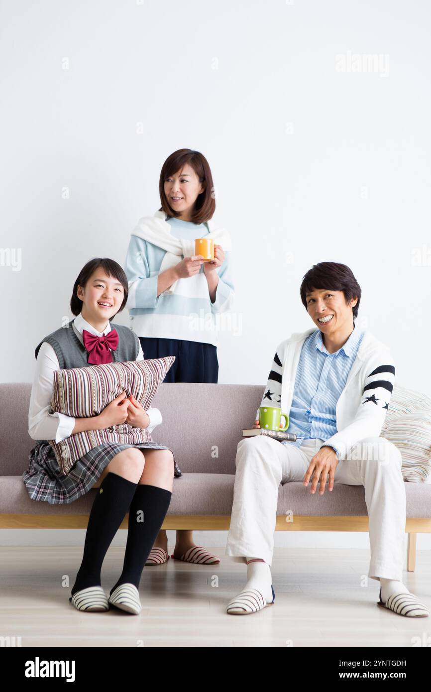 Family grouping together in a room Stock Photo - Alamy
