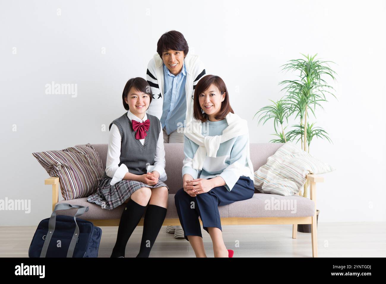 Family grouping together in a room Stock Photo - Alamy