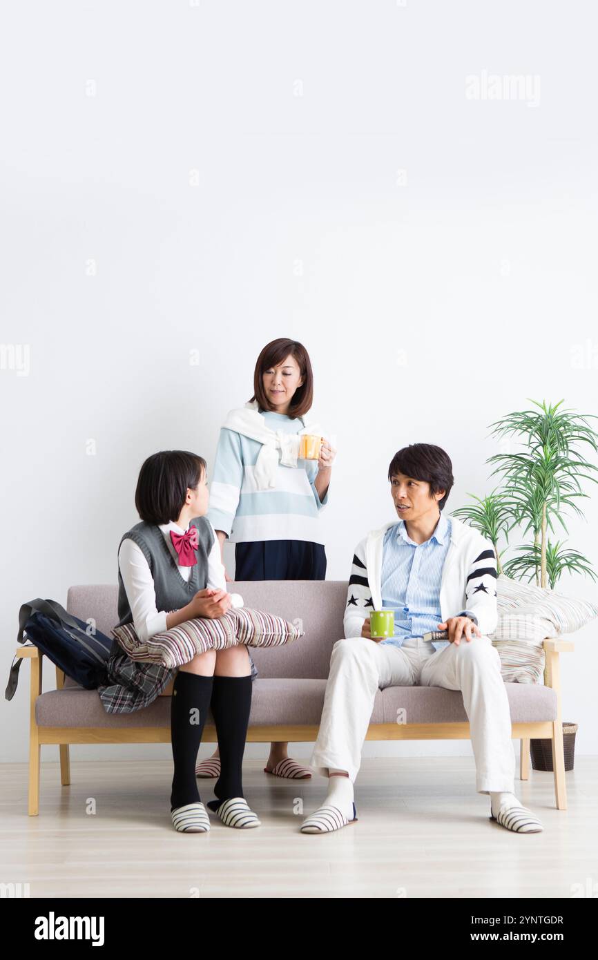 Family grouping together in a room Stock Photo - Alamy