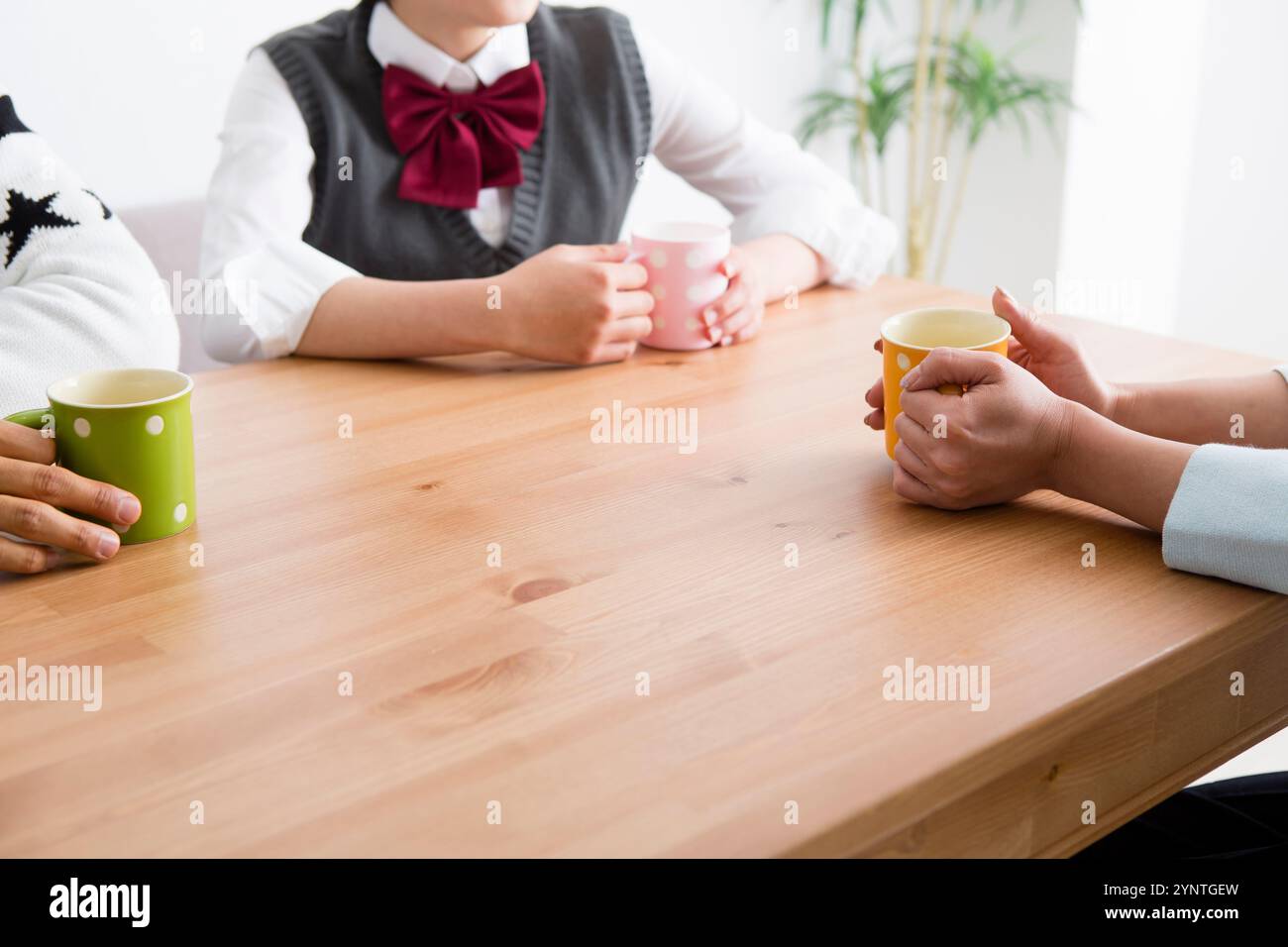Family grouping together in a room Stock Photo - Alamy