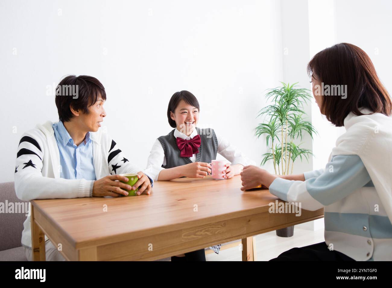 Family grouping together in a room Stock Photo - Alamy