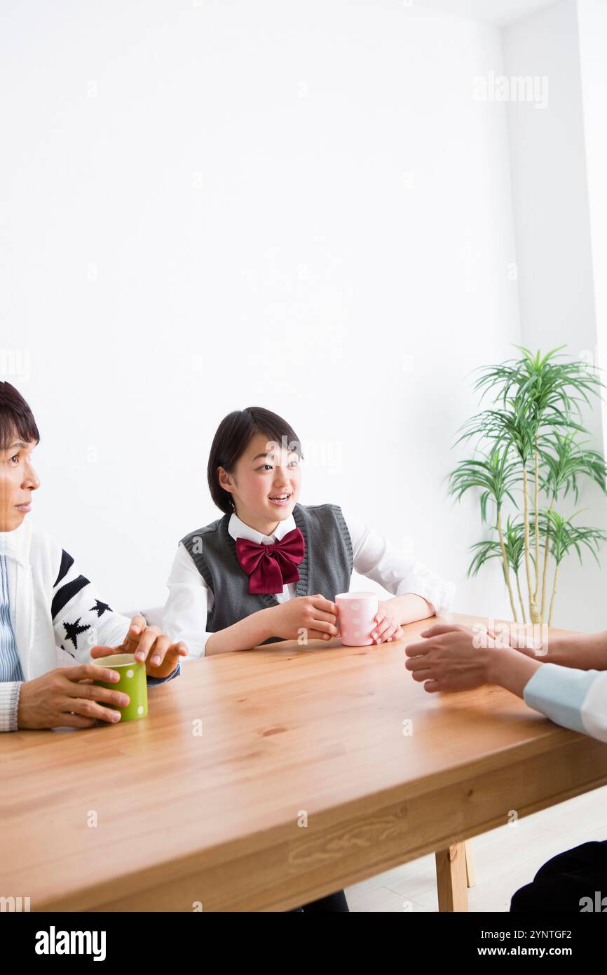 Family grouping together in a room Stock Photo - Alamy