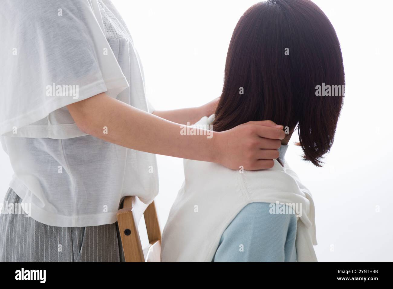 Daughter tapping mother's shoulder Stock Photo - Alamy