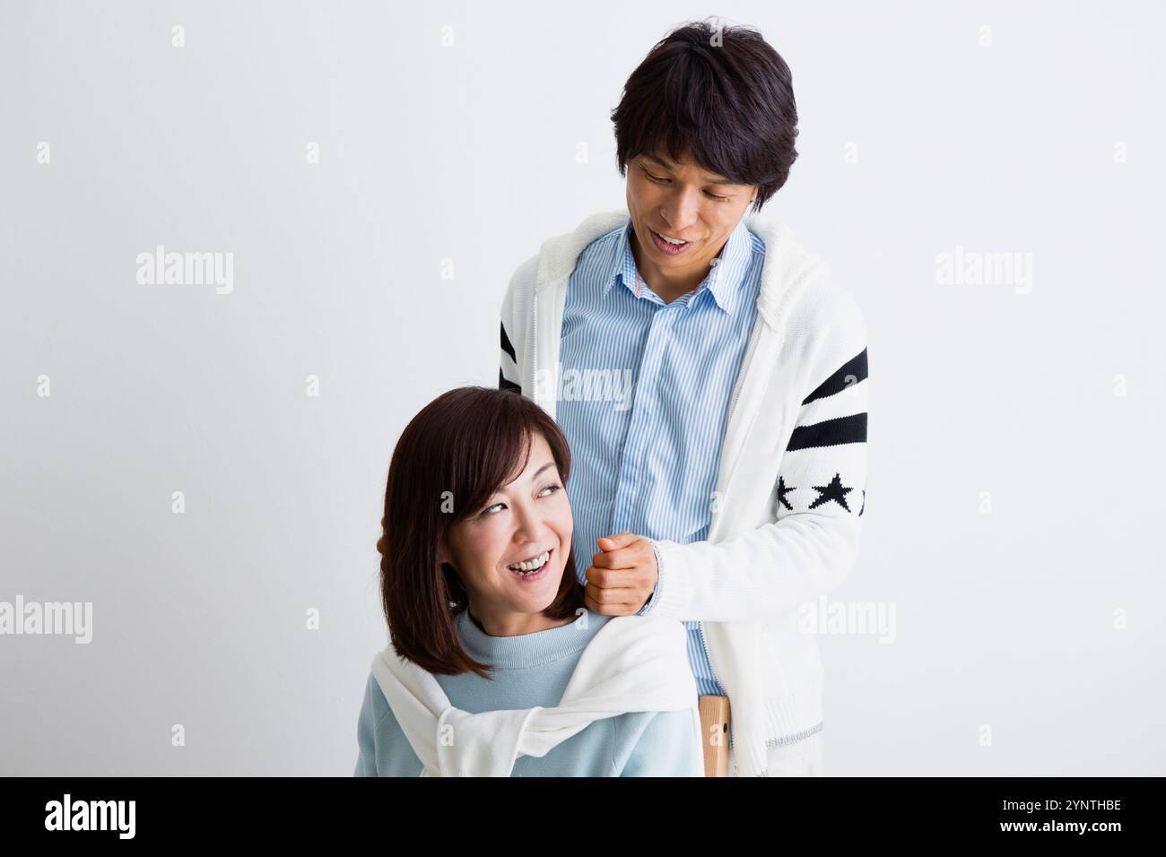 Husband tapping his wife on the shoulder Stock Photo - Alamy