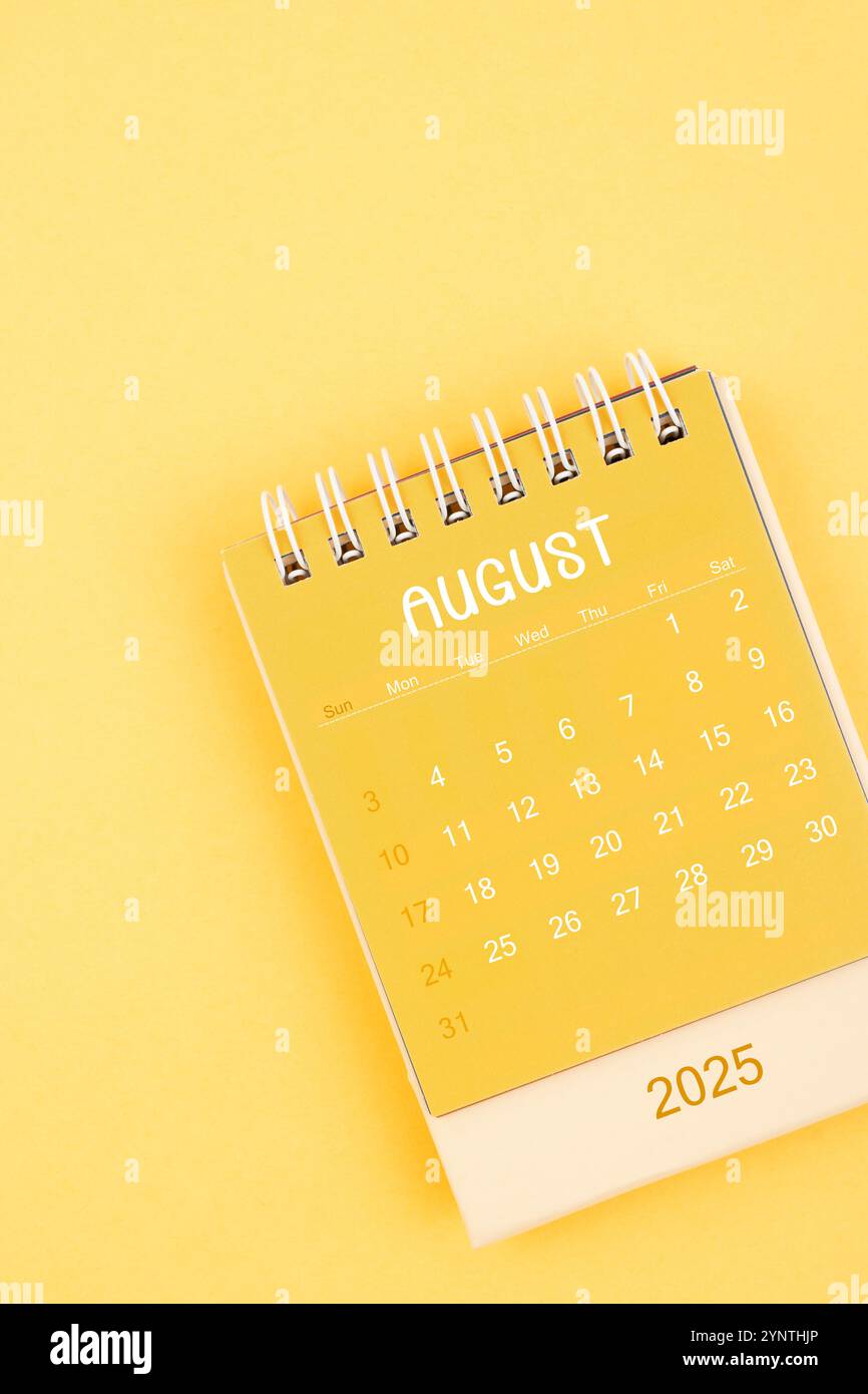 Yellow desktop calendar for August 2025 on a yellow color background ...