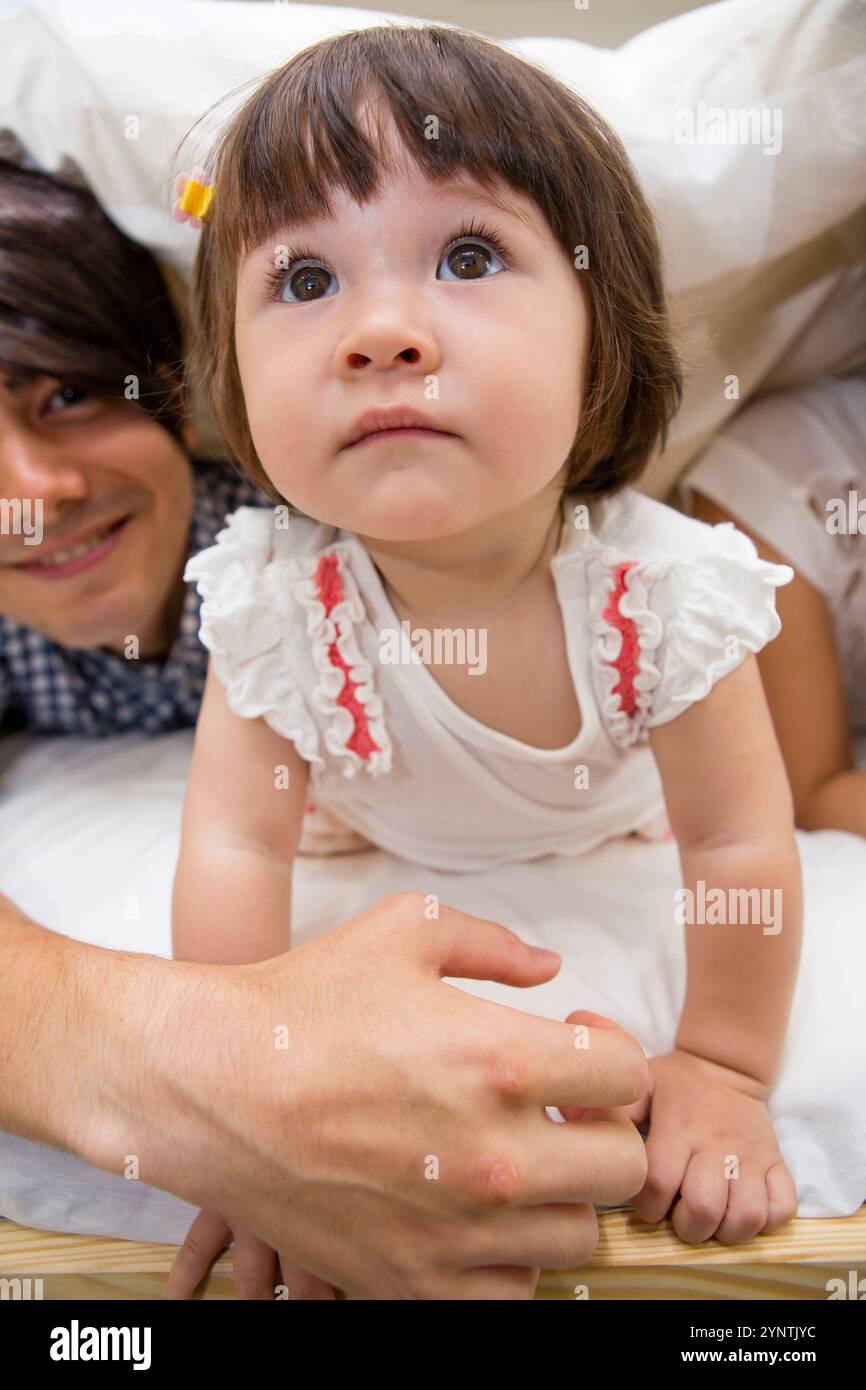 Family hiding under the duvet Stock Photo - Alamy