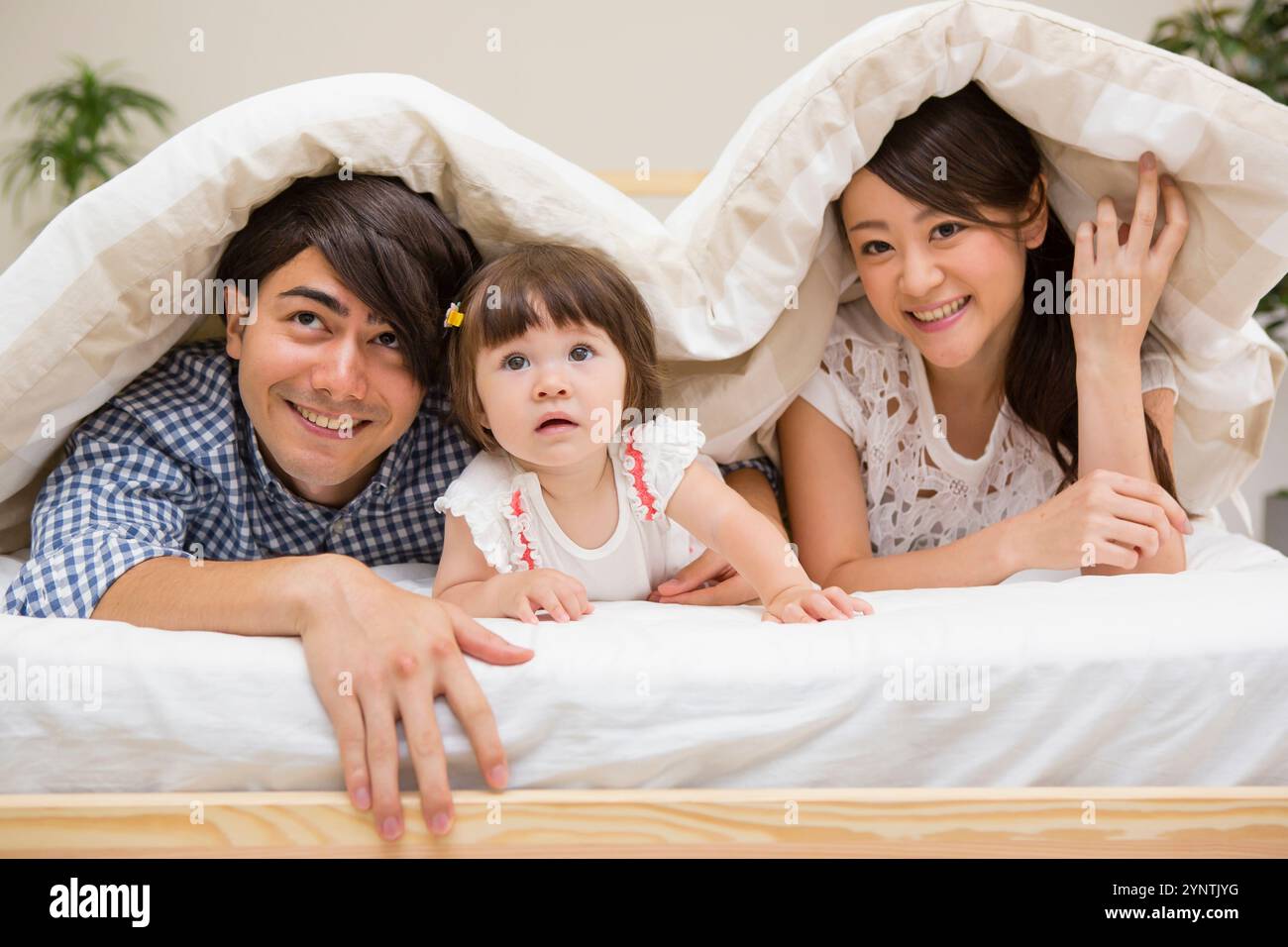 Family hiding under the duvet Stock Photo - Alamy