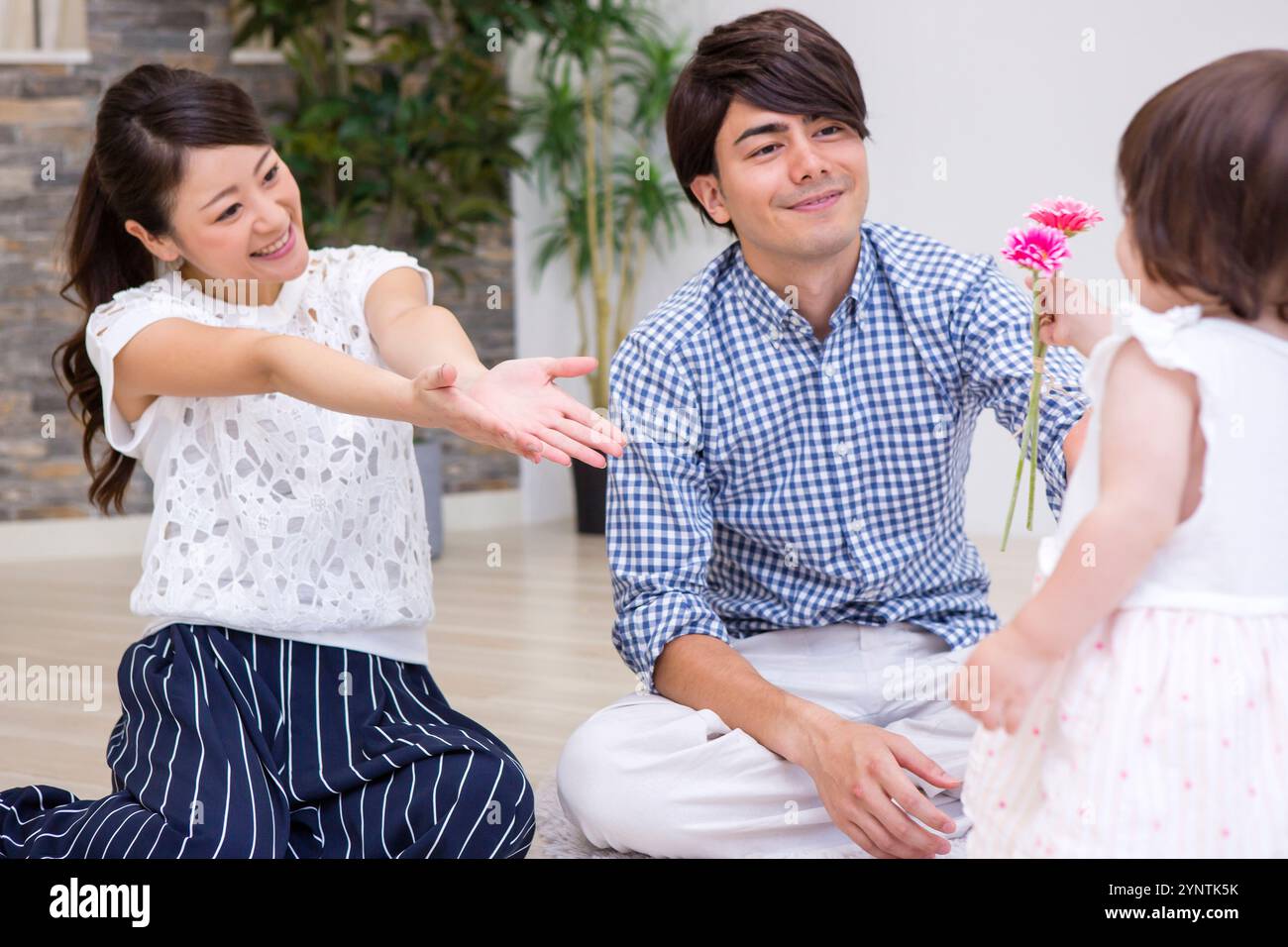 Girl giving flowers to her parents Stock Photo - Alamy