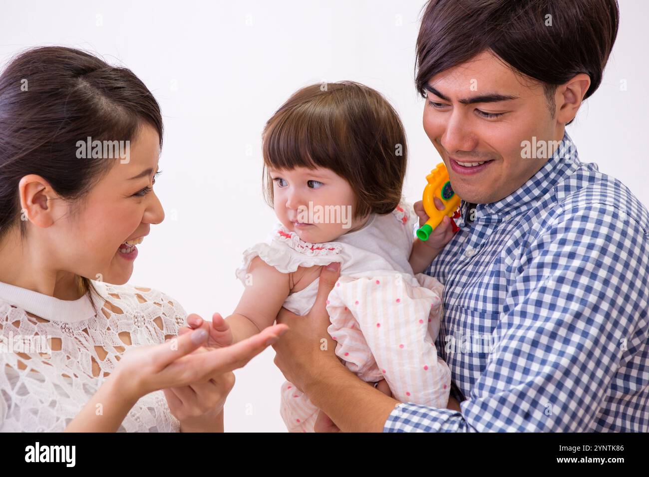 Girl being carried by family Stock Photo - Alamy