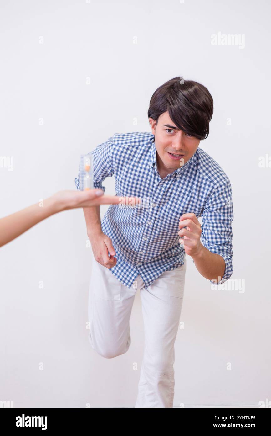 Hourglass and man dashing Stock Photo - Alamy