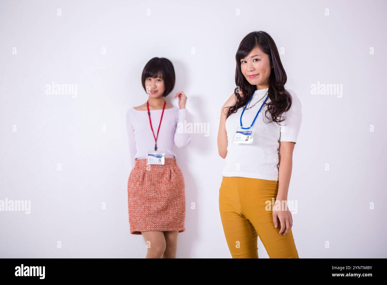 Women wearing employee ID cards Stock Photo - Alamy