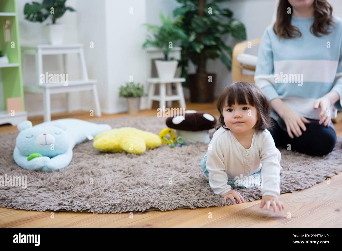 Parent and child playing in room Stock Photo - Alamy