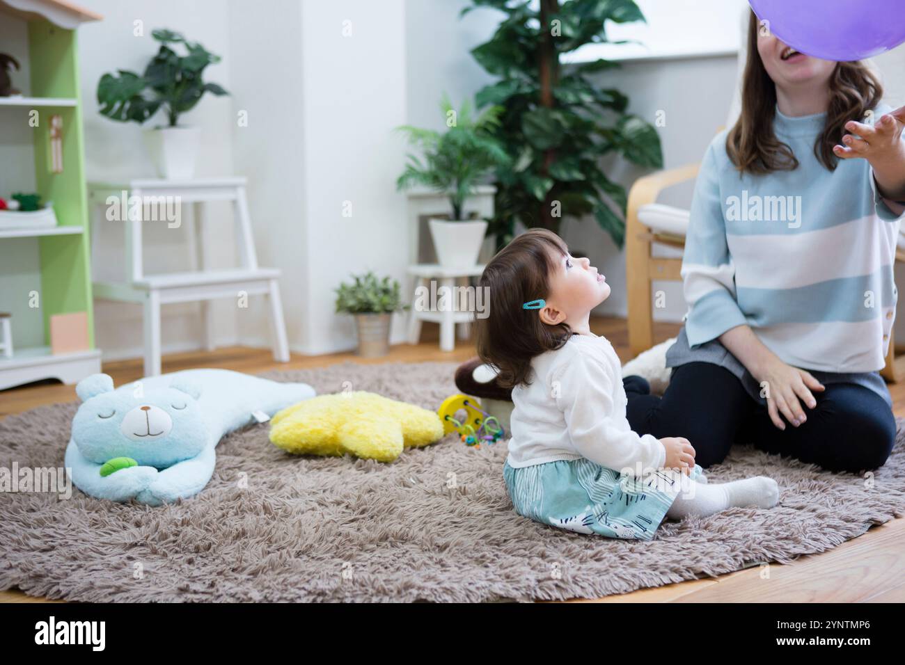 Parent and child playing in room Stock Photo - Alamy